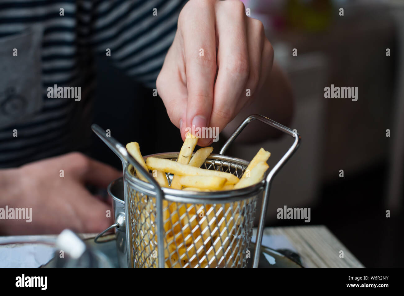 Hand holding french fries in hi-res stock photography and images - Alamy