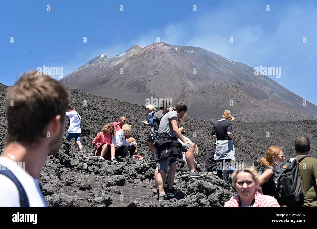 Tourists walking up Mount Etna an active volcano on the east coast of ...