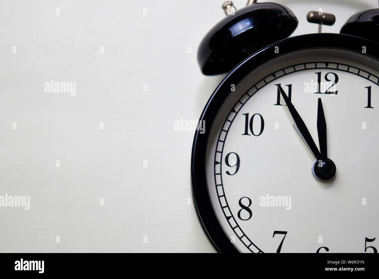 Close up black alarm clock isolated on white background Stock Photo - Alamy