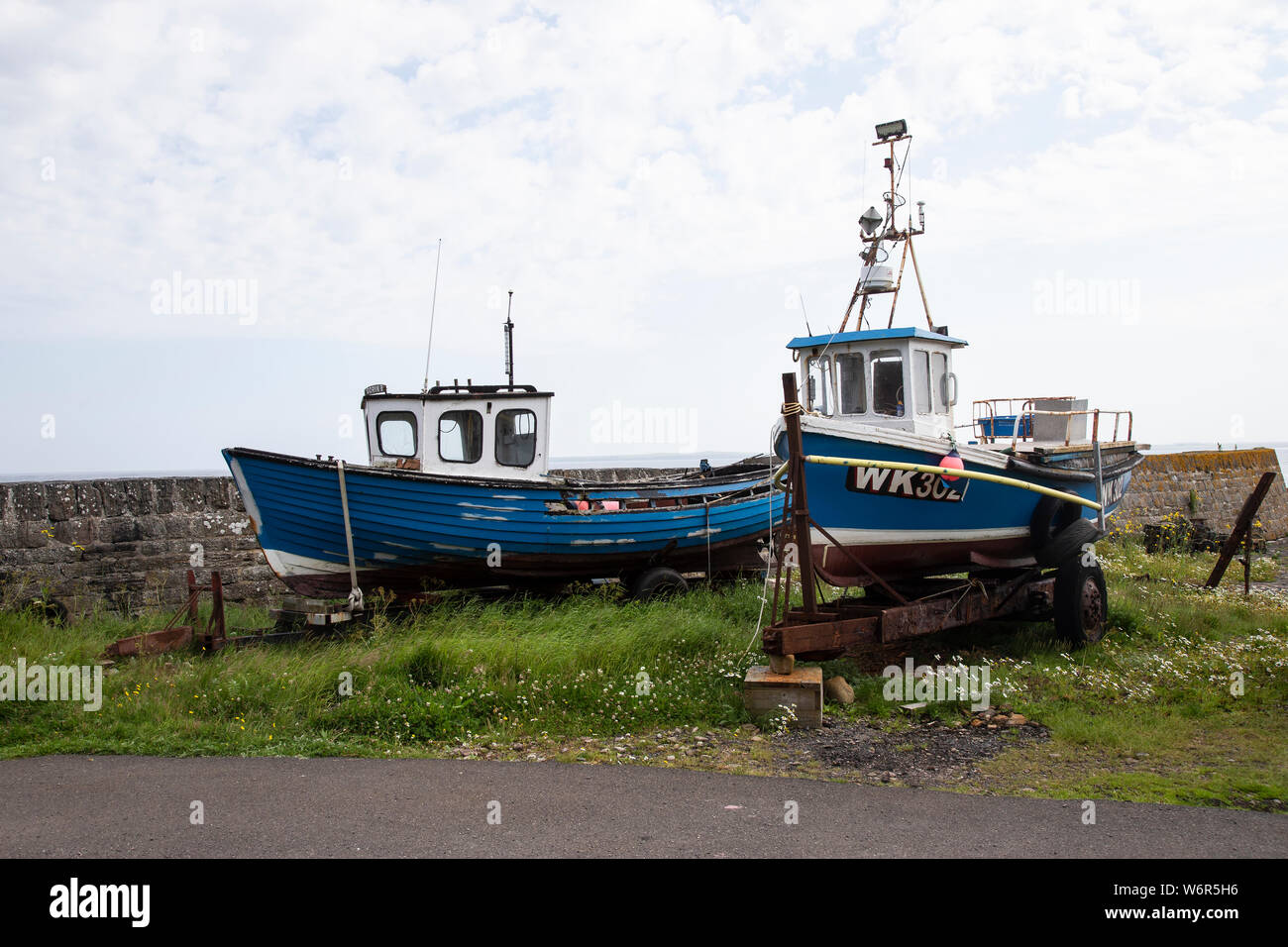 Two abandoned fishing boats in Keiss harbour, Caithness including WK302 ...