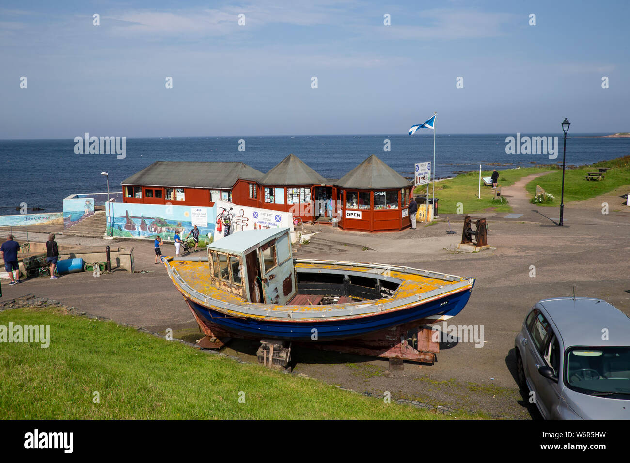 Old boat and tourist kiosks at John O Groats in Caithness, Scotland ...