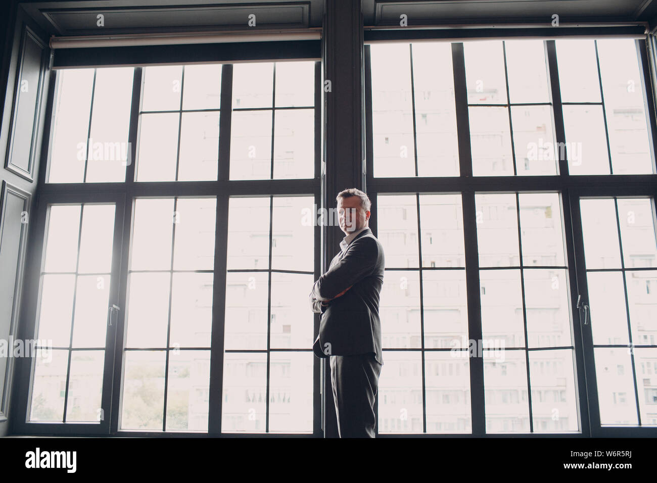 Portrait of a businessman at big window. Business and success concept ...