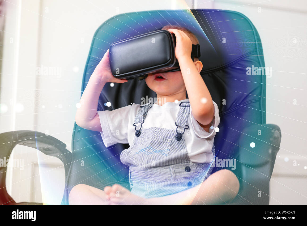 Child using new Virtual Reality, VR cardboard glasses. happy little boy ...