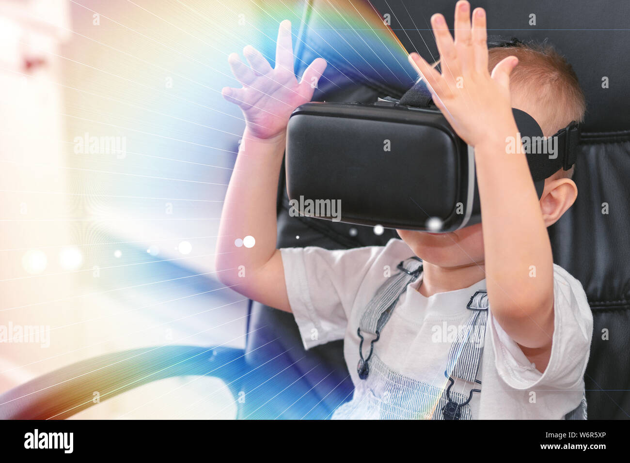 Child using new Virtual Reality, VR cardboard glasses. happy little boy ...