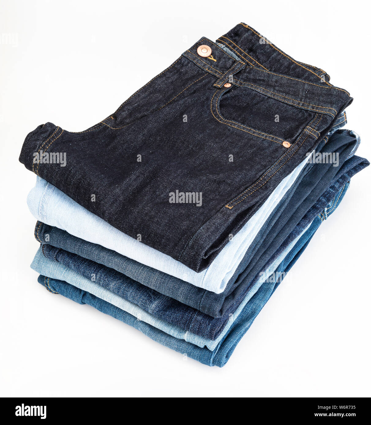 Heap of jeans of various shades. Isolated on white background Stock ...