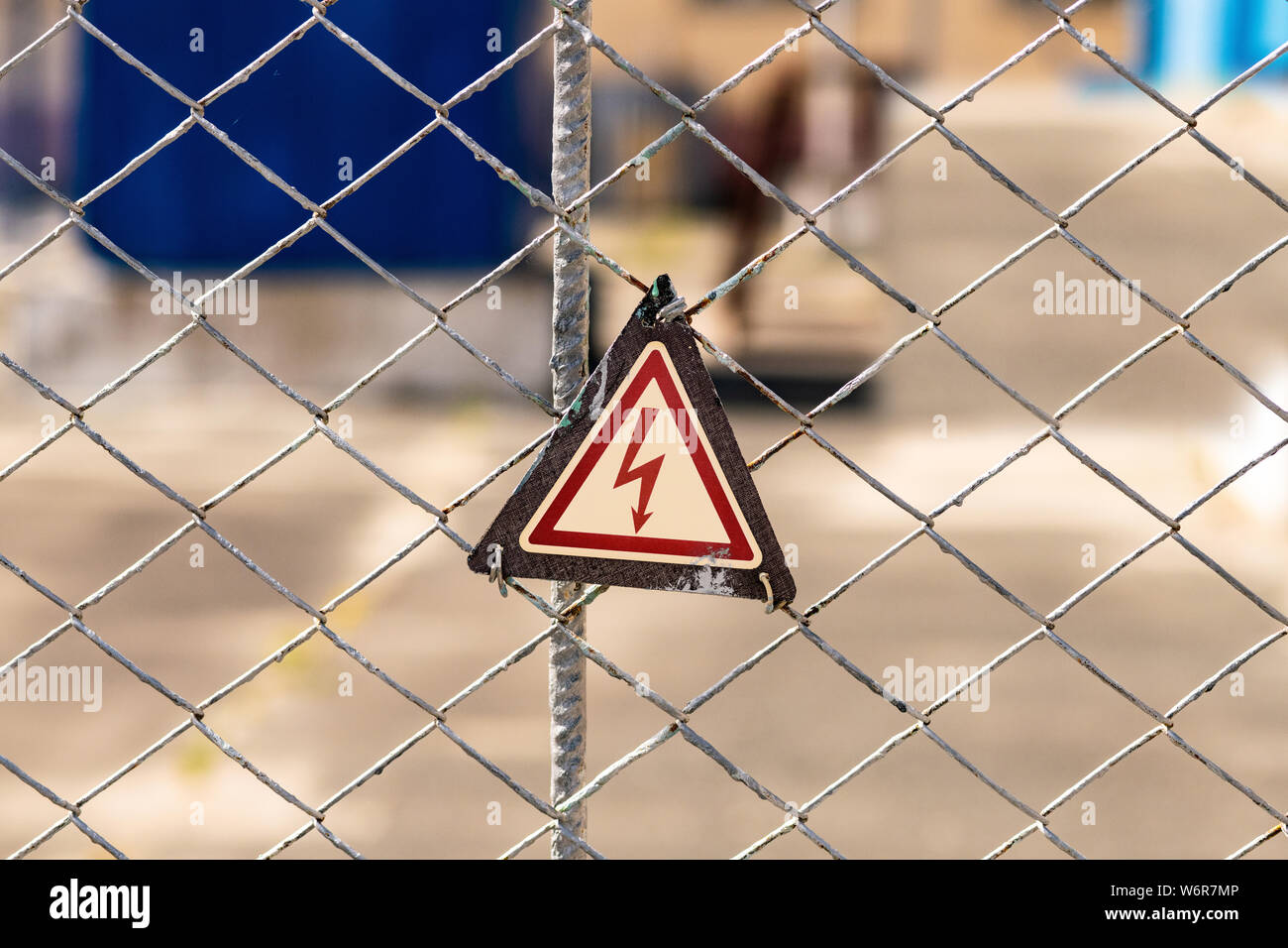 High voltage hazard warning sign on the fence. Power substation with ...
