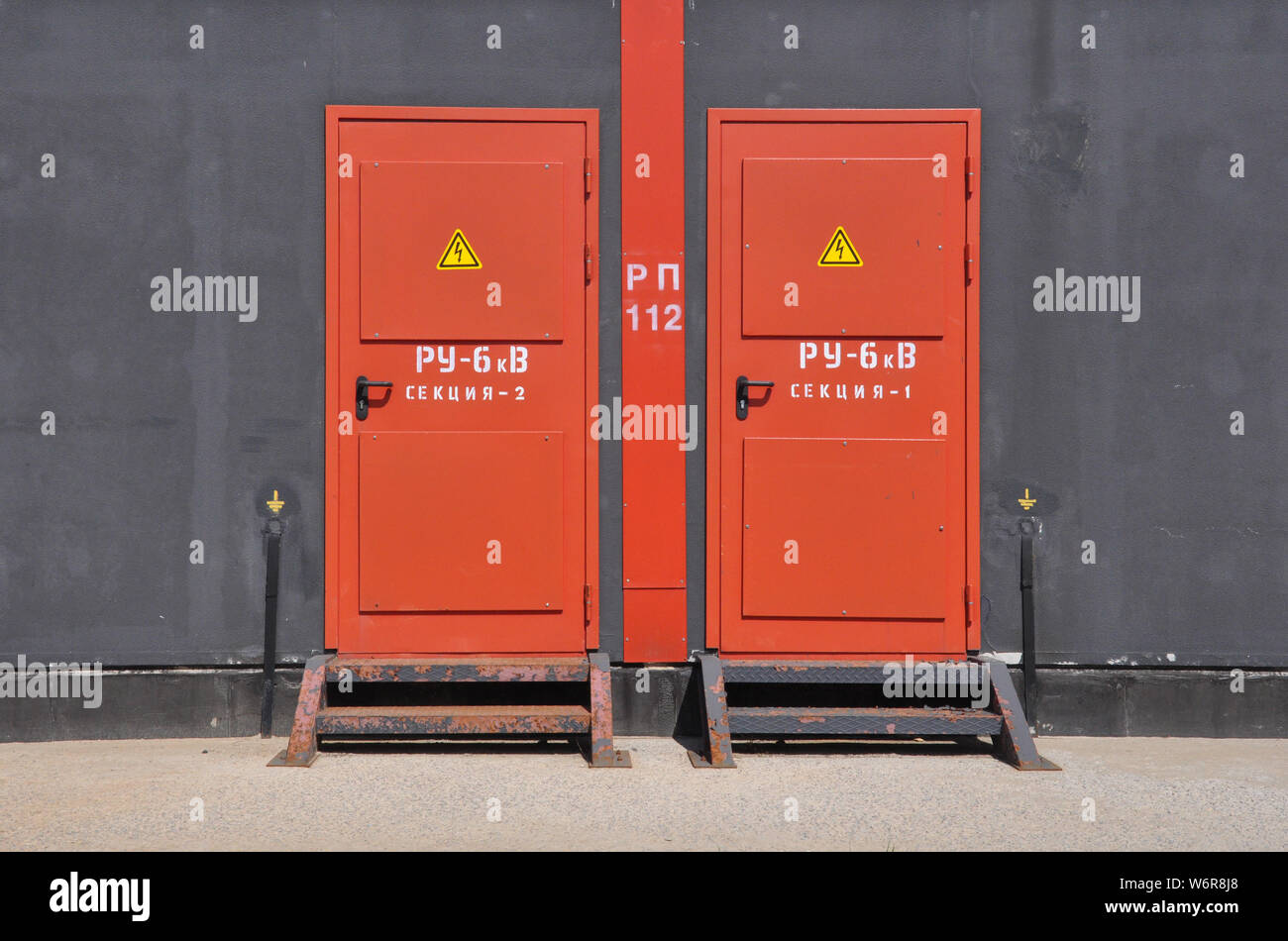Iron red door of a transformer box. Electricity, high voltage, do not ...