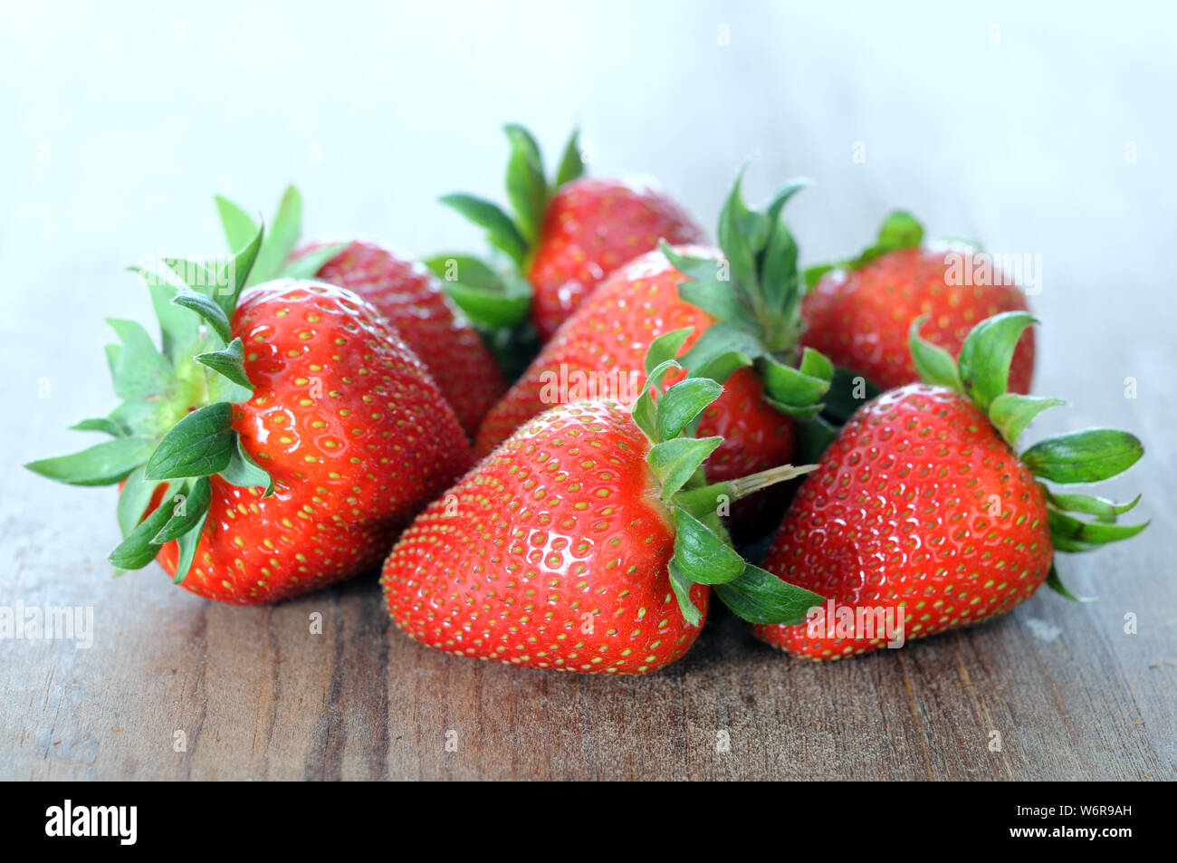 group of fresh strawberry lay on rustic table Stock Photo - Alamy