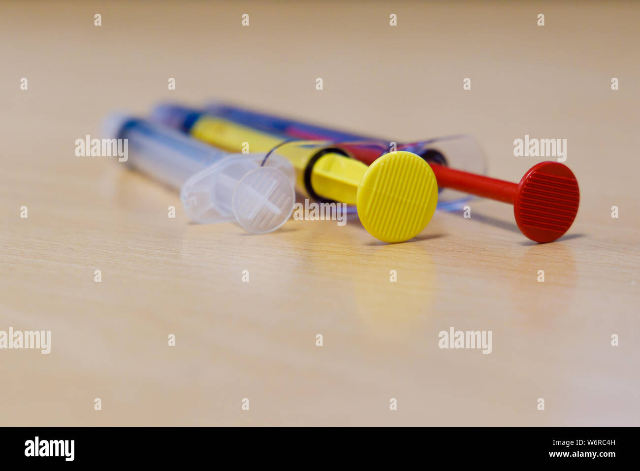 Three small medical syringes of different size and colors Stock Photo ...