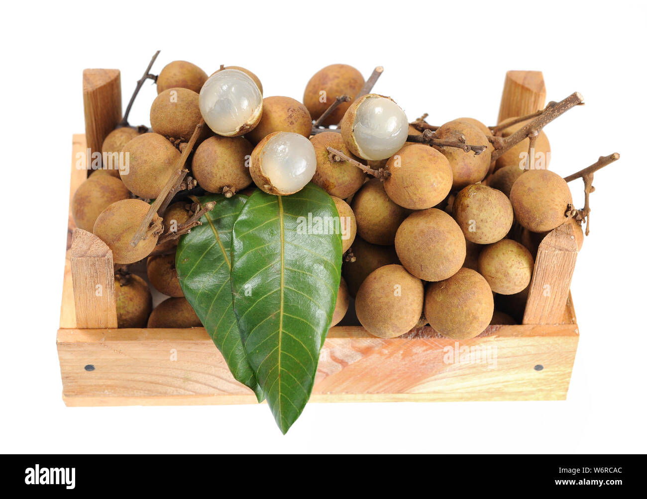 juicy and delicious longan in wooden crate isolated on white background ...
