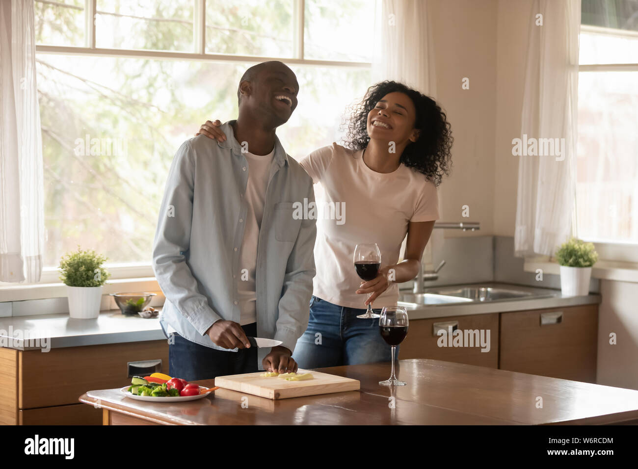 Romantic african couple enjoy date while cooking in the kitchen Stock ...