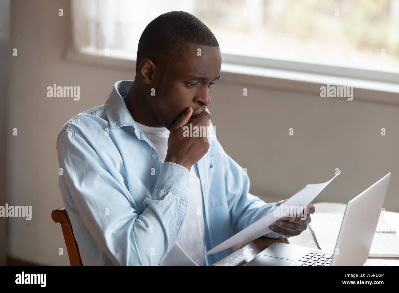 African guy reading paper hi-res stock photography and images - Alamy