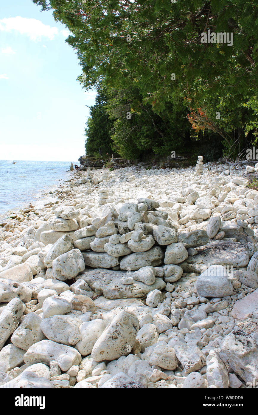 The rocky shoreline of Lake Michigan in the summer in Cave Point County ...