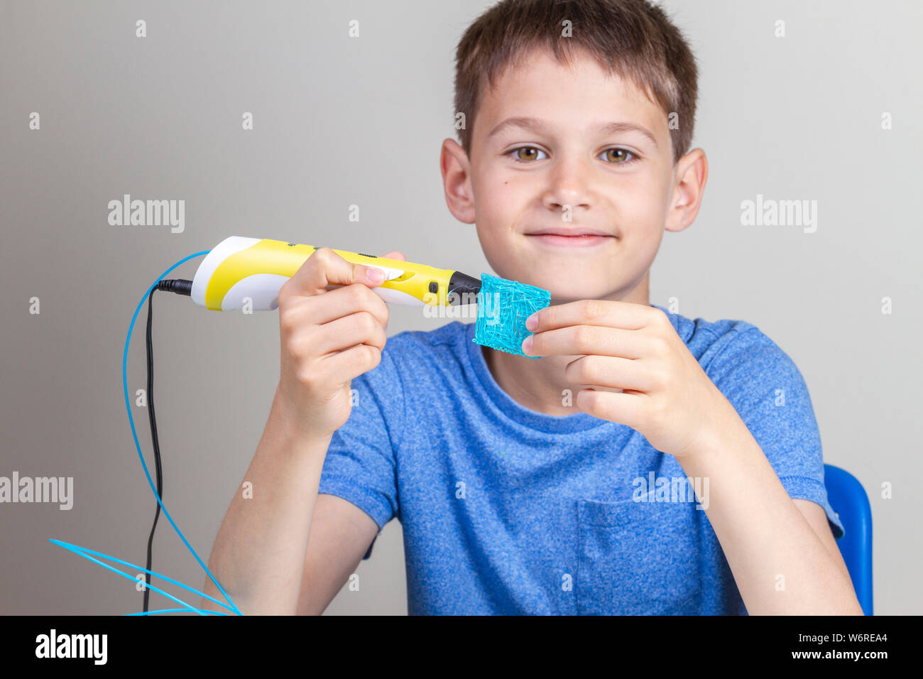 Boy creating with 3 d pen Stock Photo - Alamy