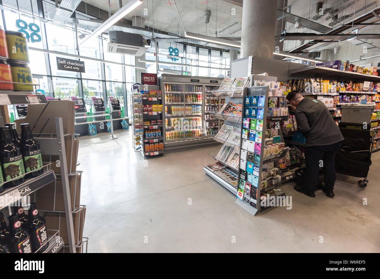 A worker stacks sheves inside a Co-Op food store Stock Photo - Alamy
