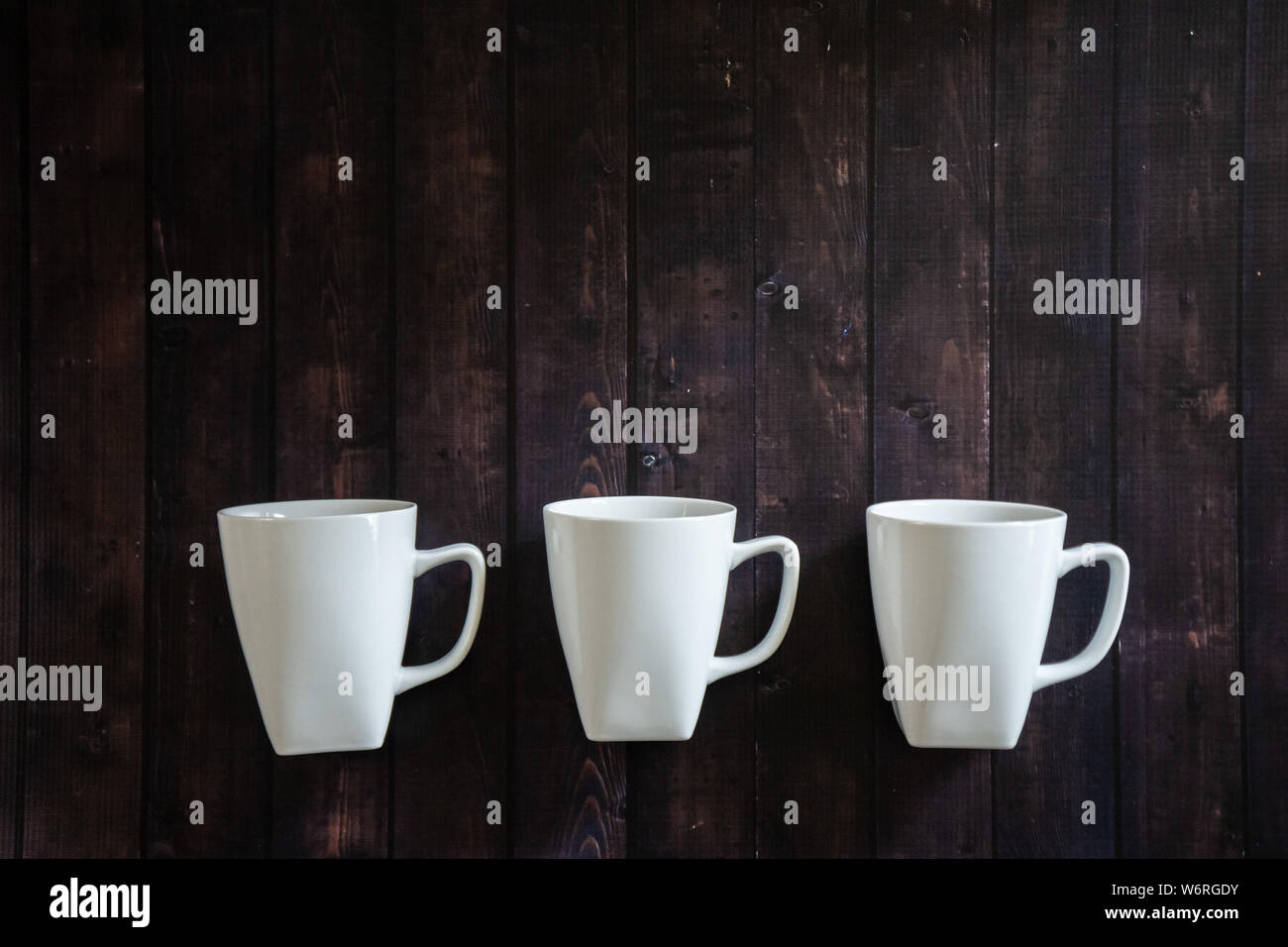 3 coffee mugs on a wooden table background - morning espresso java pick ...