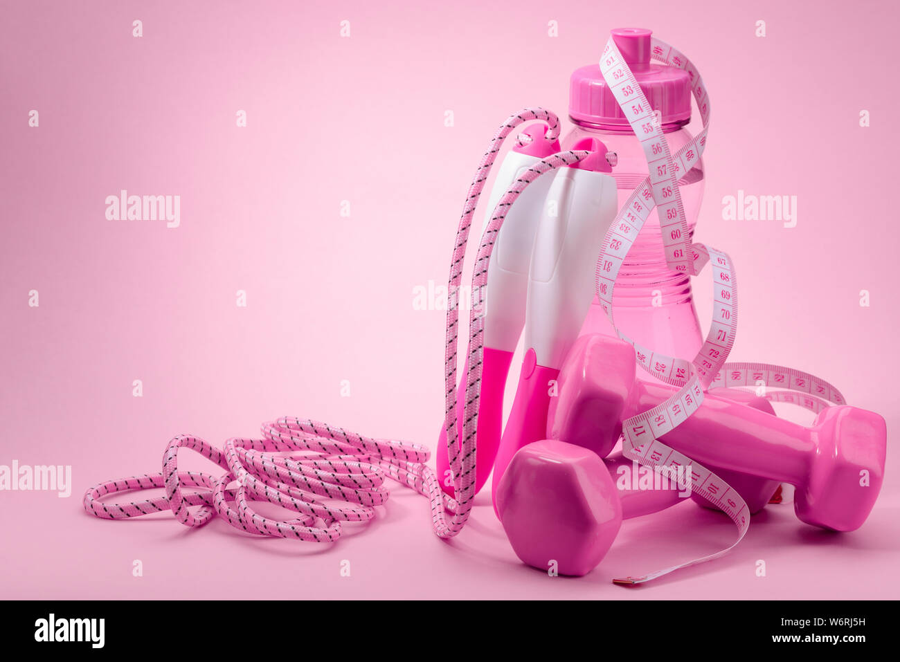 Water, dumbbells, a jump rope Stock Photo - Alamy