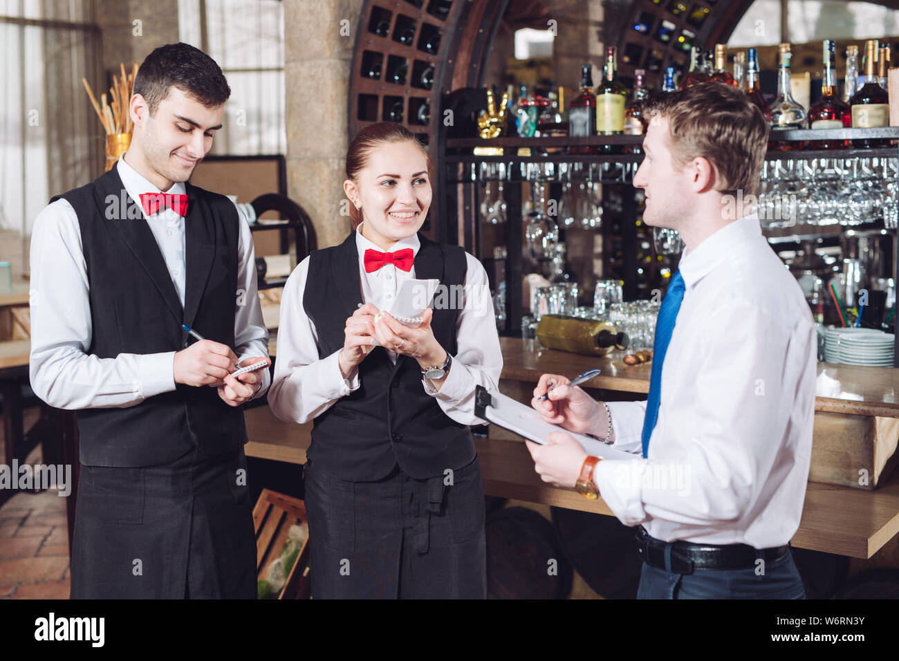Manager's briefing with the waiters. Restaurant manager and his staff ...