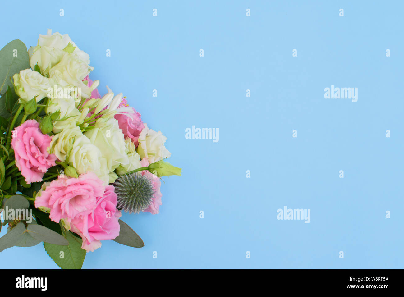 Colorful beautiful bouquet of different fresh flowers on the light blue ...