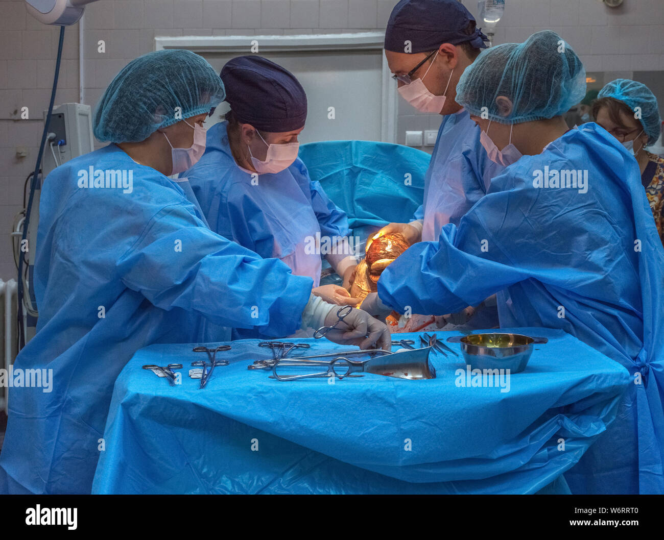 New life, baby being born via Caesarean Section in the operating room ...
