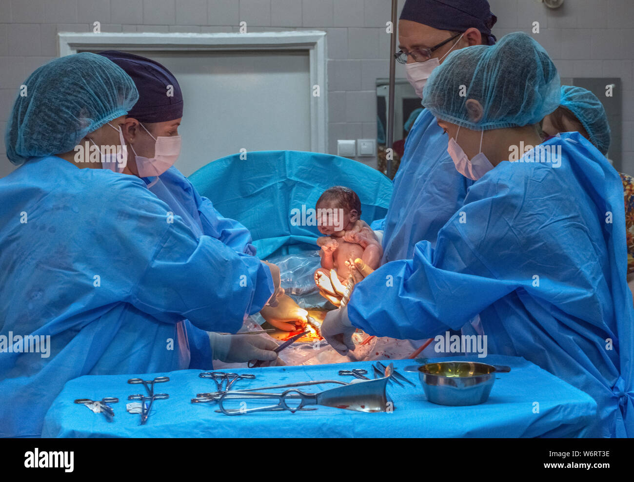 New life, baby being born via Caesarean Section in the operating room ...