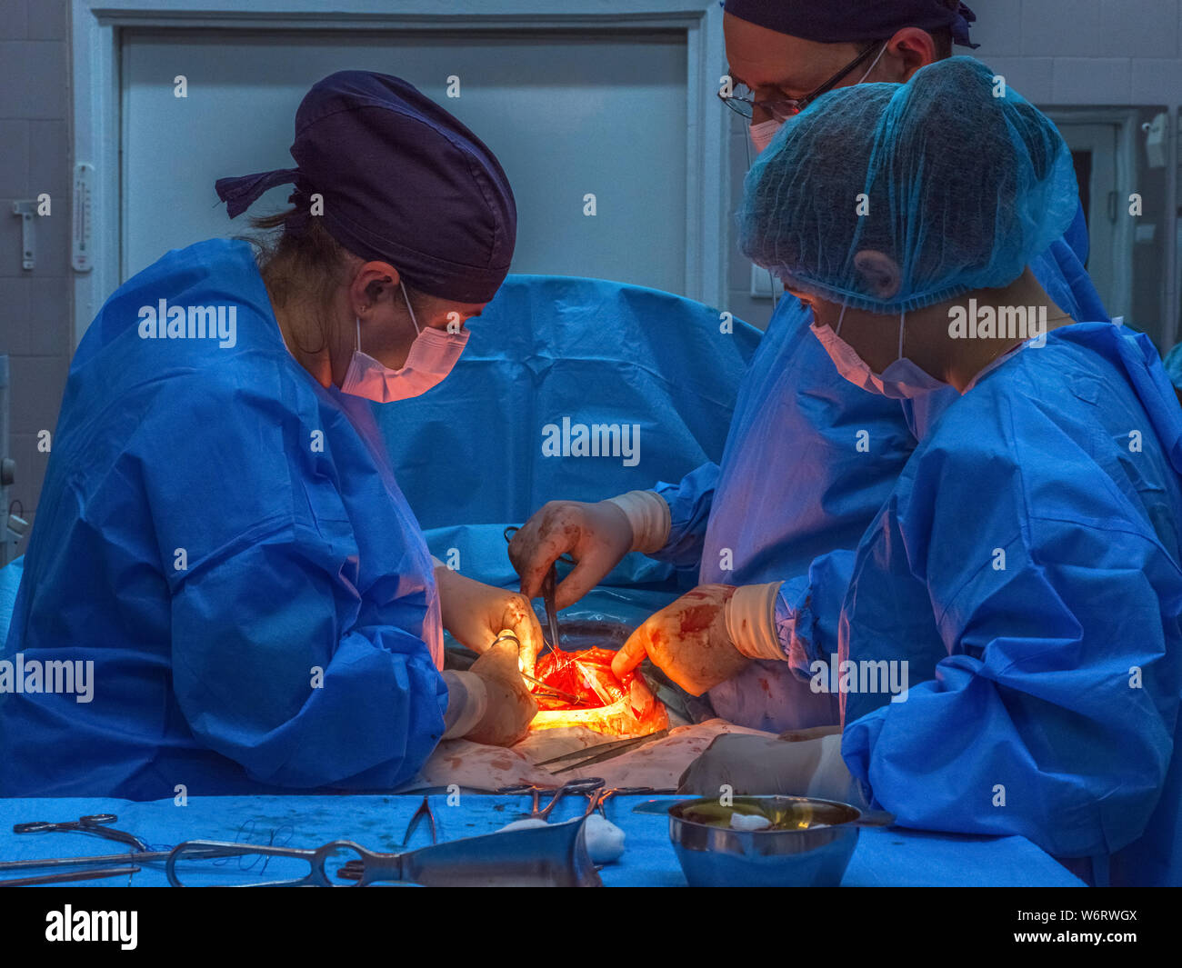 Doctor surgery team in the operating room of abdominal cesarean section ...