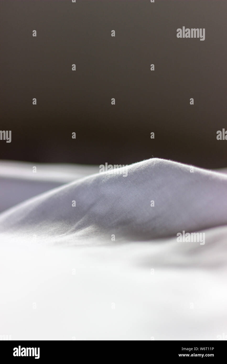 Folds in white cloth close up in shallow depth of field Stock Photo - Alamy