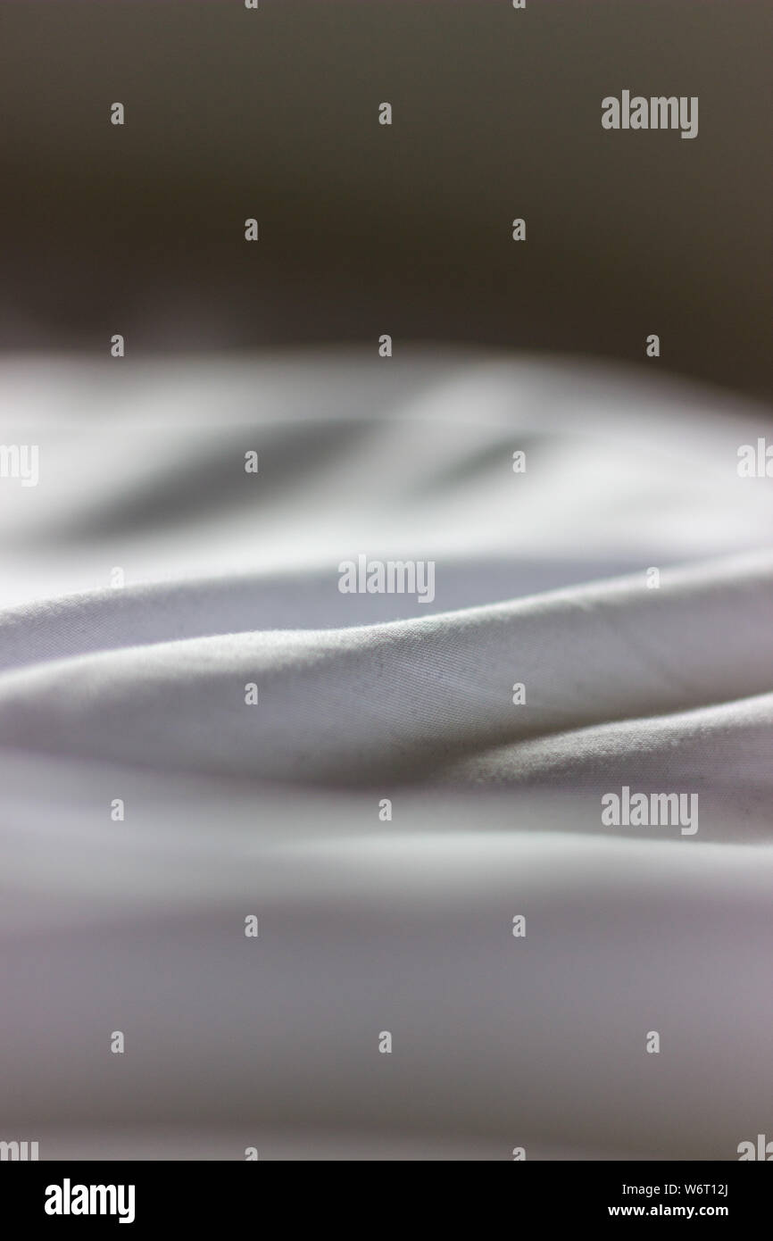 Folds in white cloth close up in shallow depth of field Stock Photo - Alamy