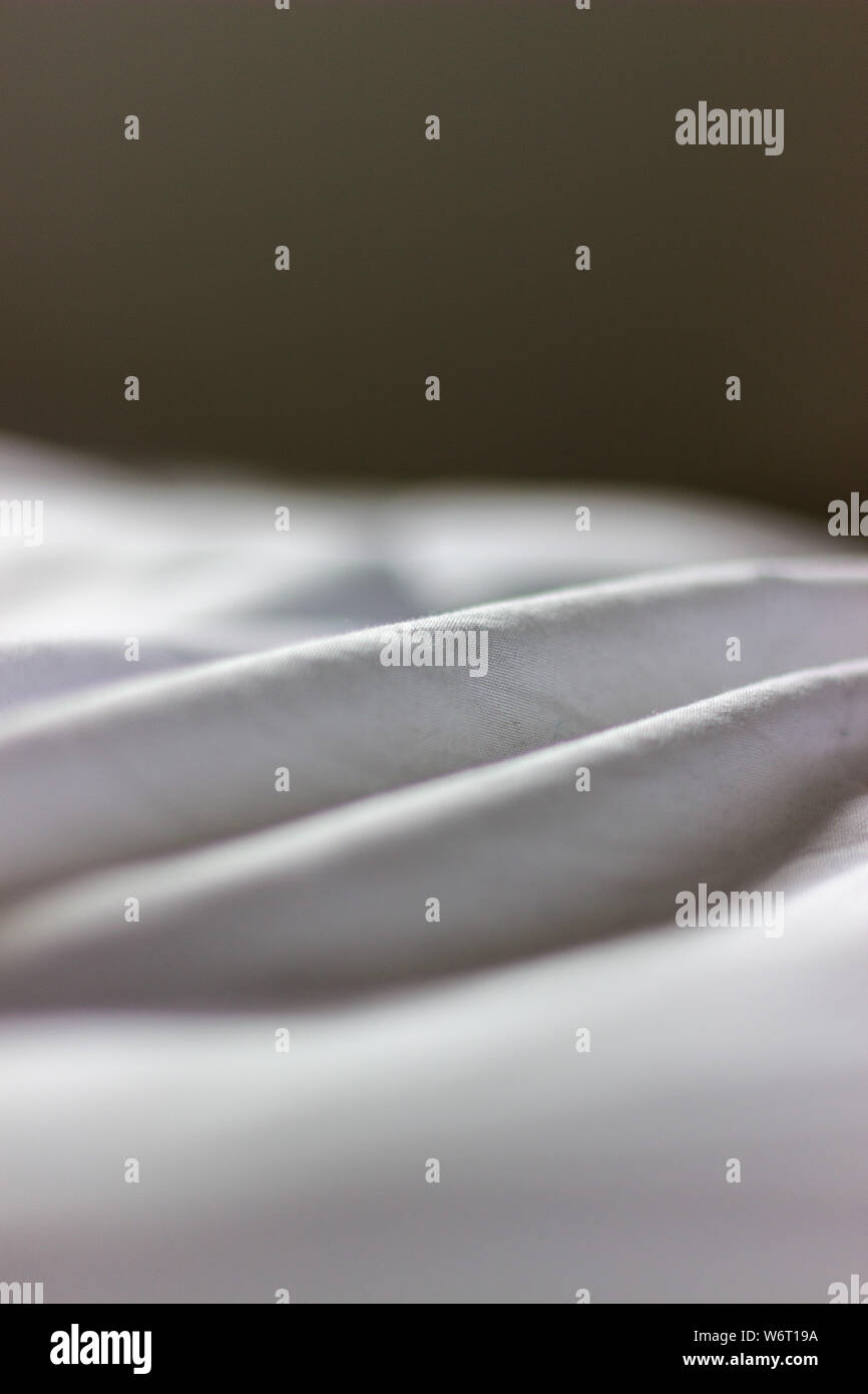 Folds in white cloth close up in shallow depth of field Stock Photo - Alamy