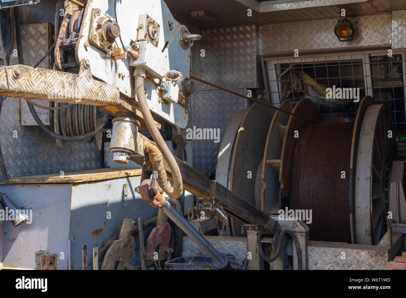 Wireline equipment hanging from top drive ready to be lowered downhole ...