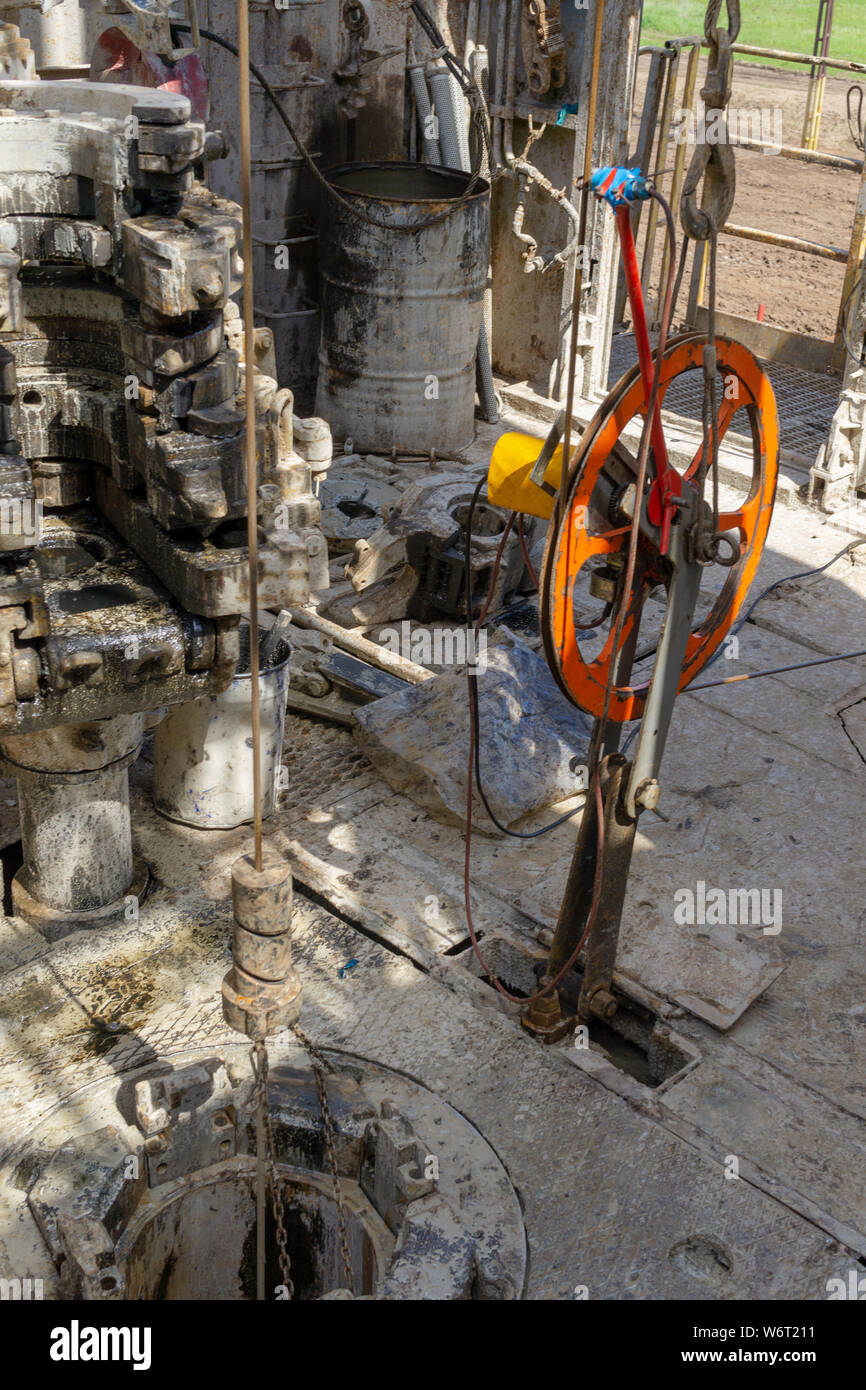 Wireline equipment hanging from top drive ready to be lowered downhole ...