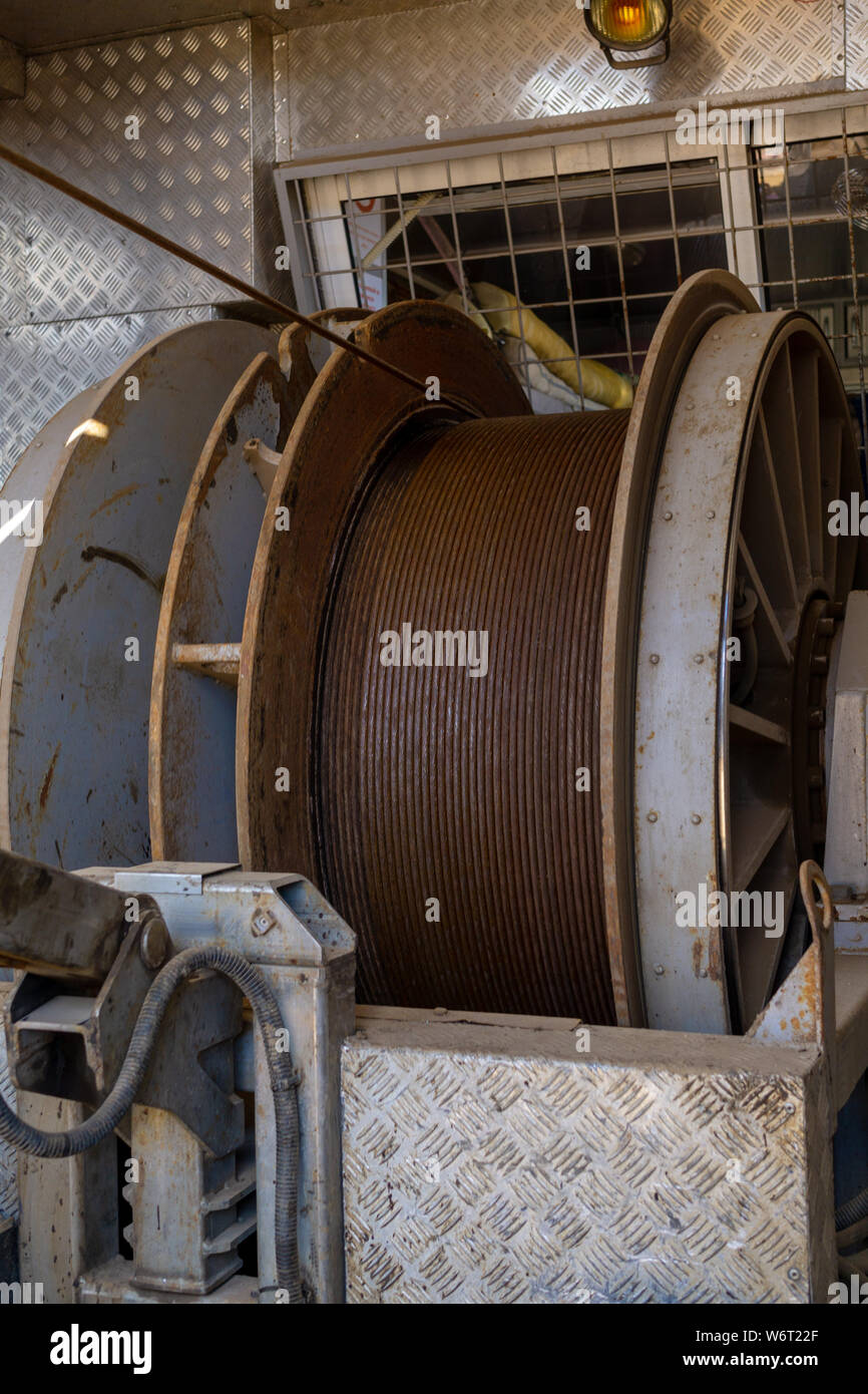 Wireline equipment hanging from top drive ready to be lowered downhole ...