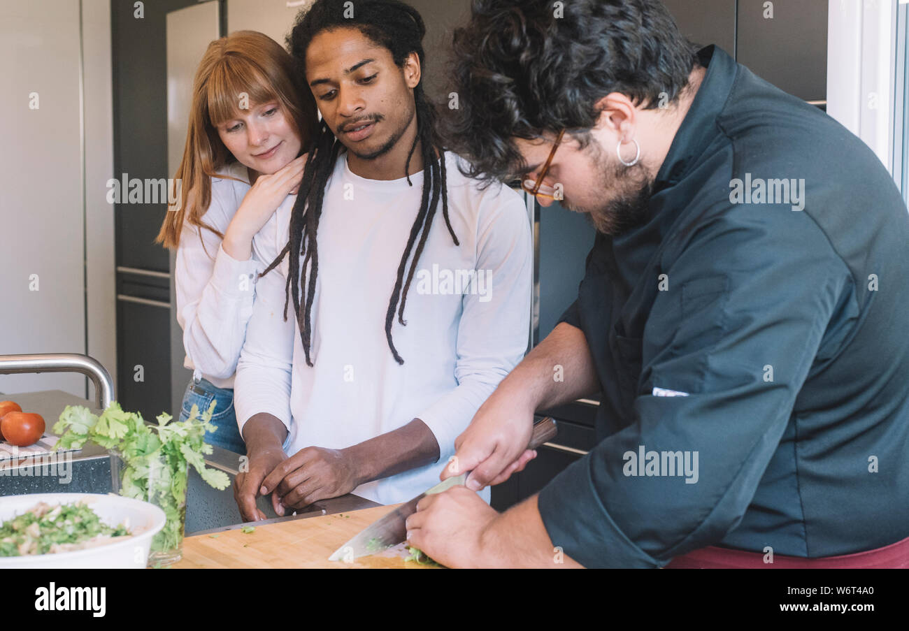 Chef teaching a multiracial couple how to make a meal Stock Photo - Alamy