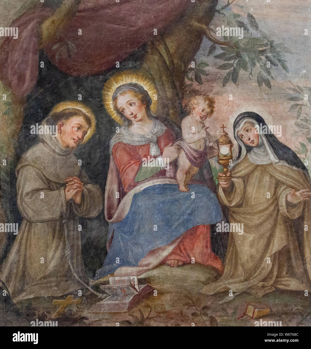 A fresco of the Virgin Mary with Infant Jesus among Saint Francis of ...