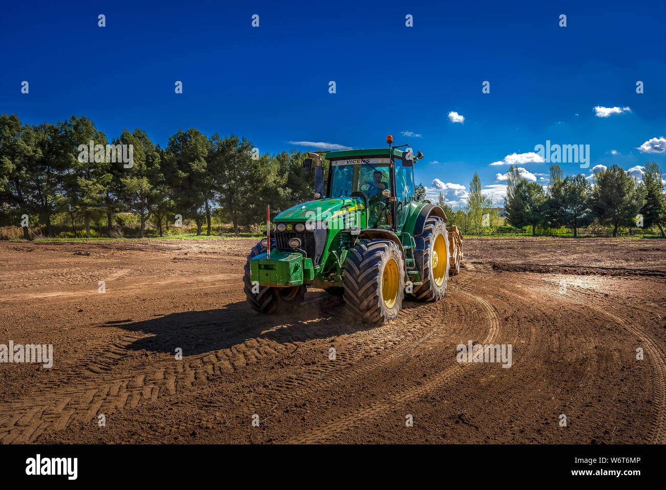 Tractors leveling in the field Stock Photo - Alamy