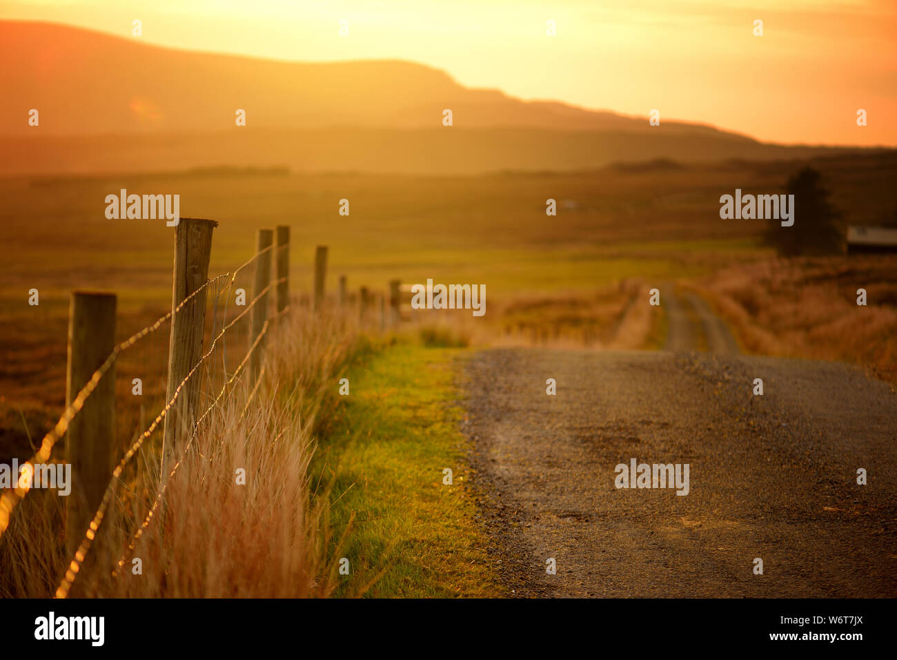 Beautiful sunset in Connemara. Scenic Irish countryside road leading ...