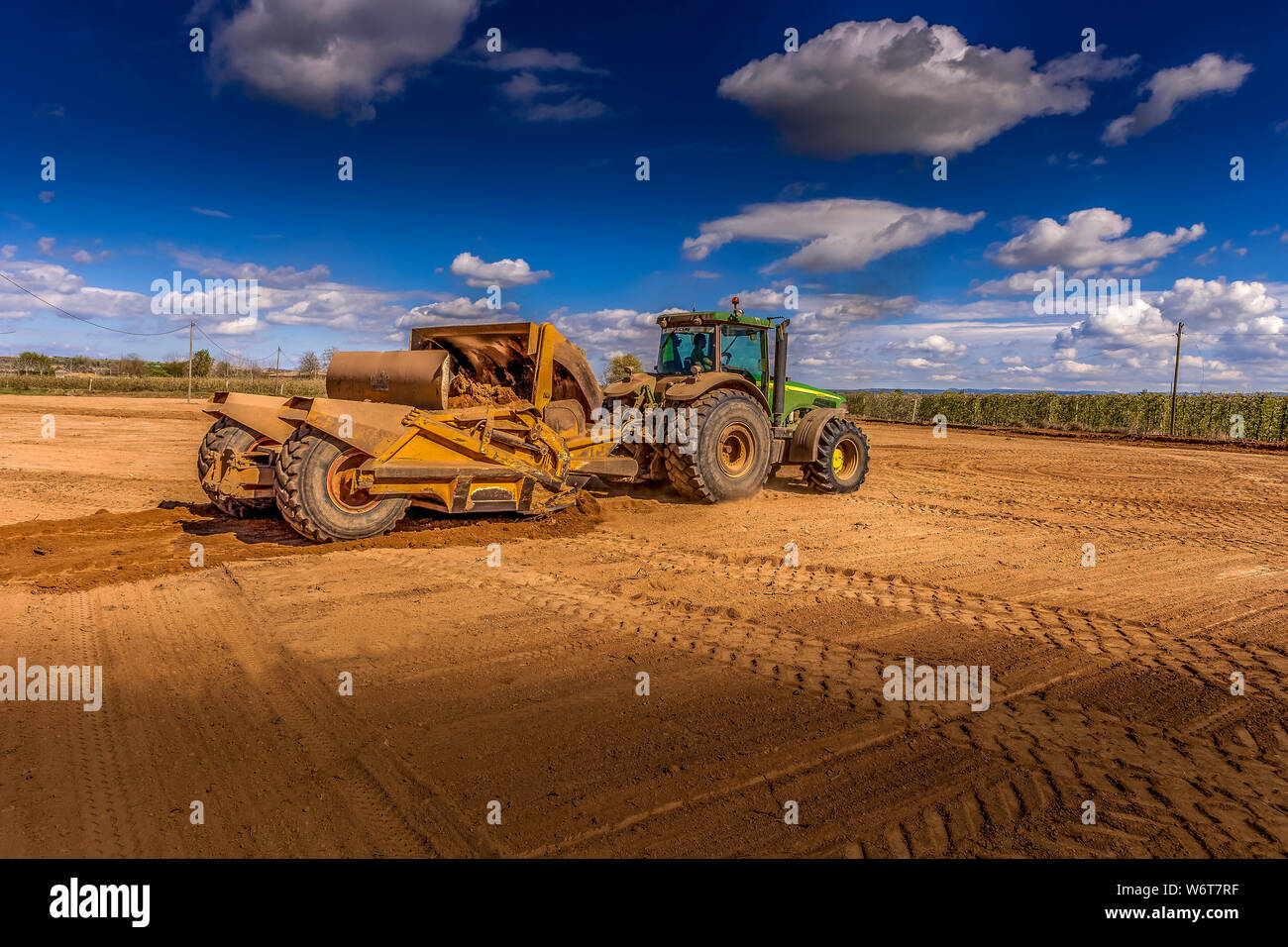 Tractors leveling in the field Stock Photo - Alamy