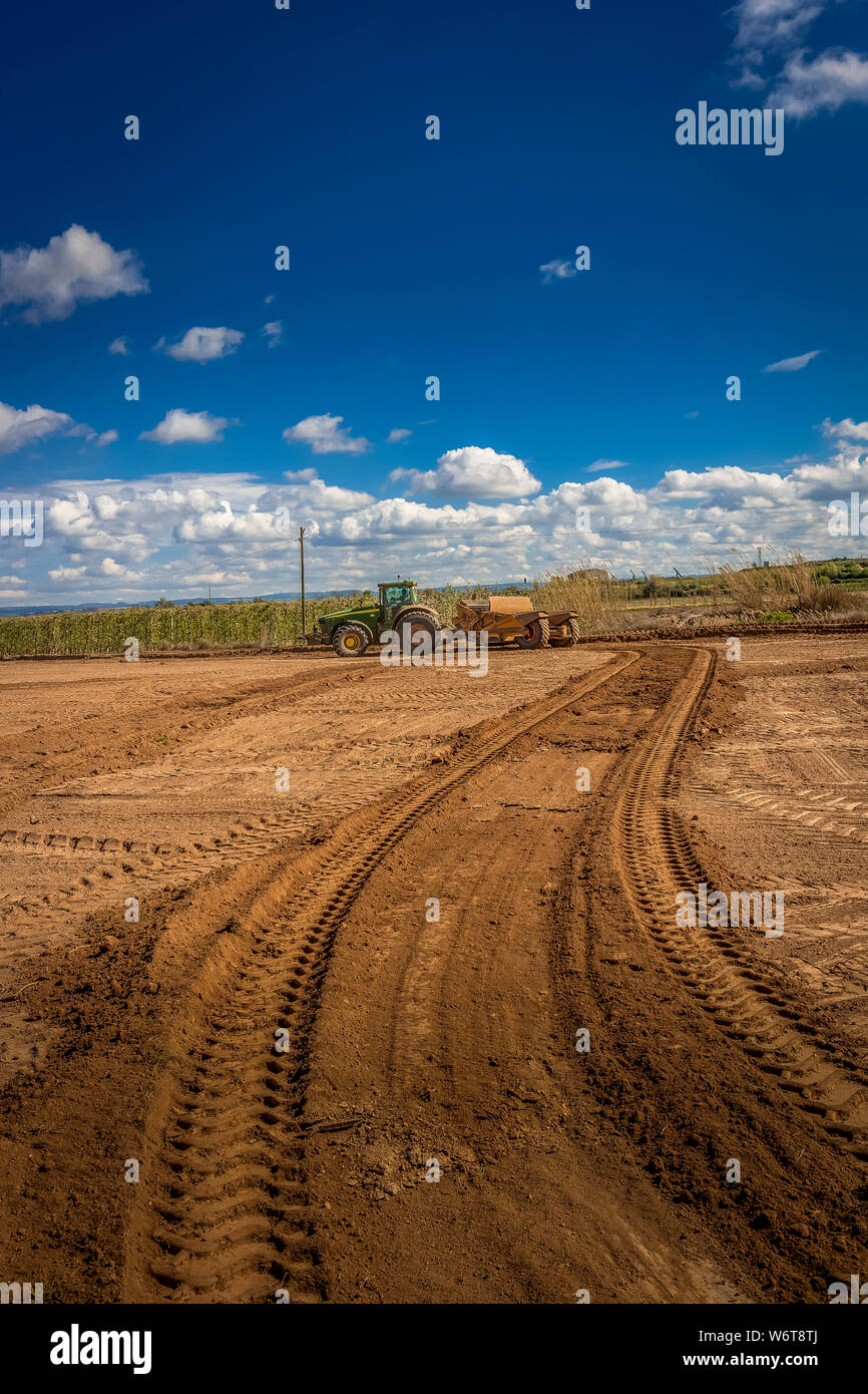 Tractors leveling in the field Stock Photo - Alamy