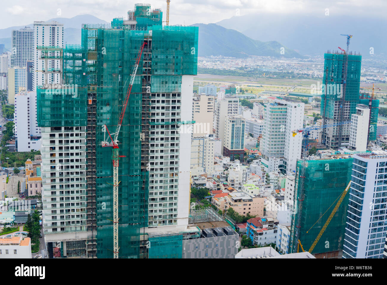High-rise building, crane, blue sky, white clouds. Construction of ...
