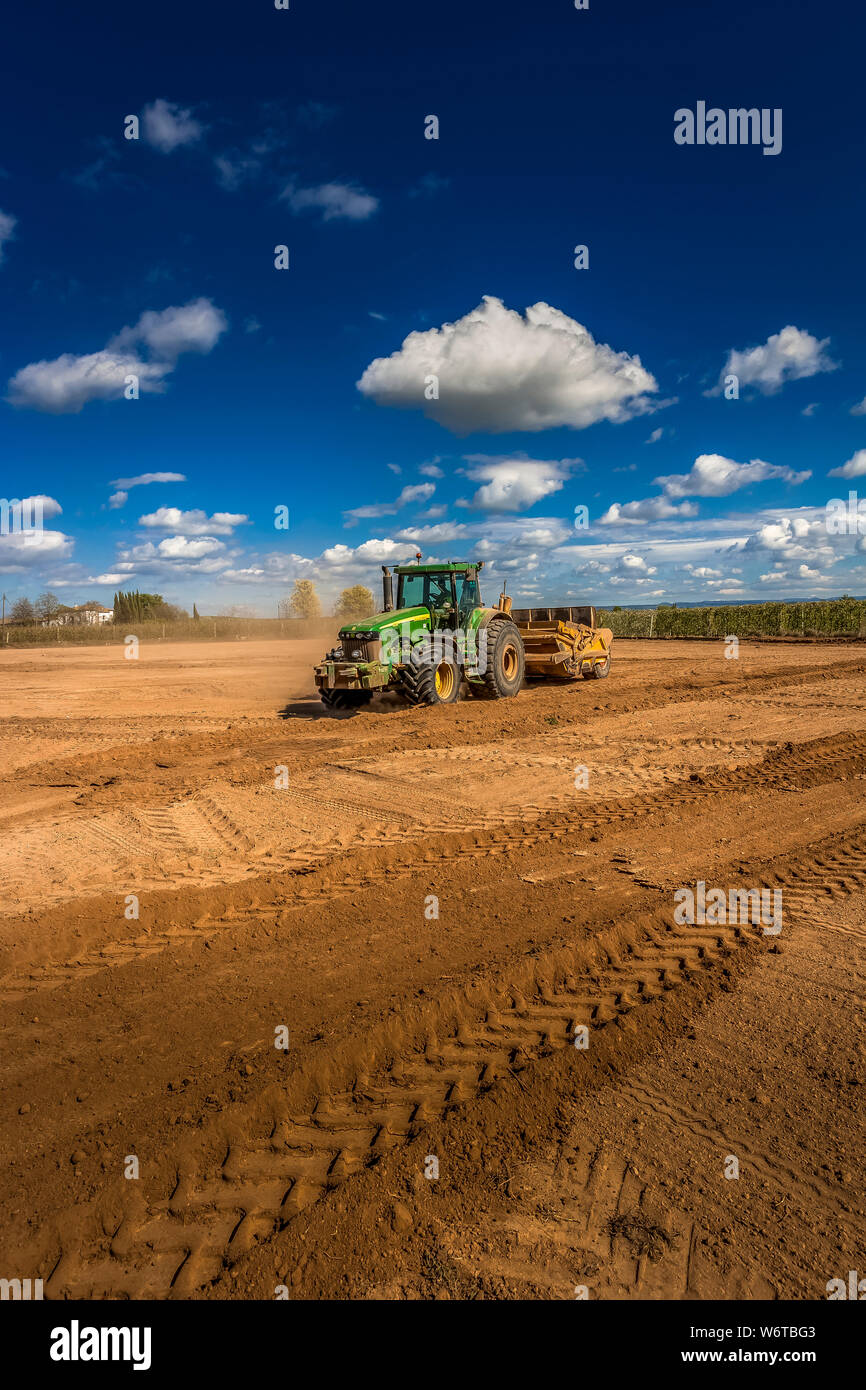Tractors leveling in the field Stock Photo - Alamy