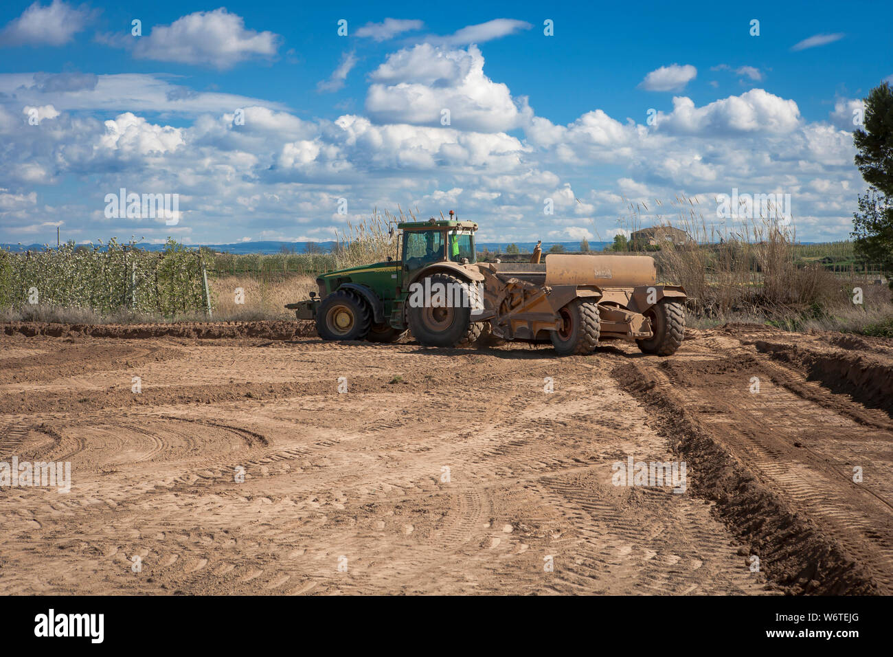 Tractors leveling in the field Stock Photo - Alamy