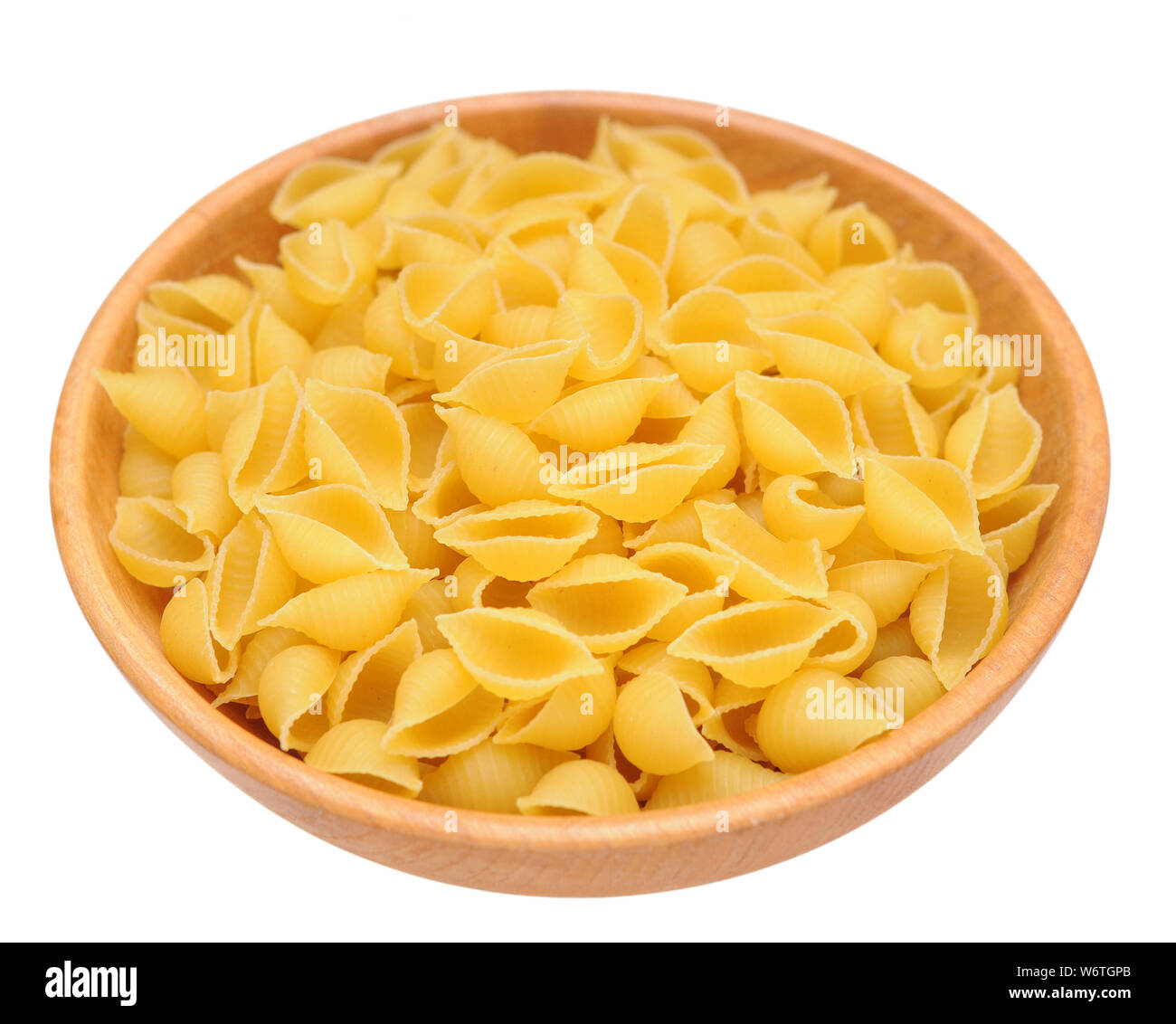 Conchiglie seashell shape pasta in wooden bowl isolated on white ...