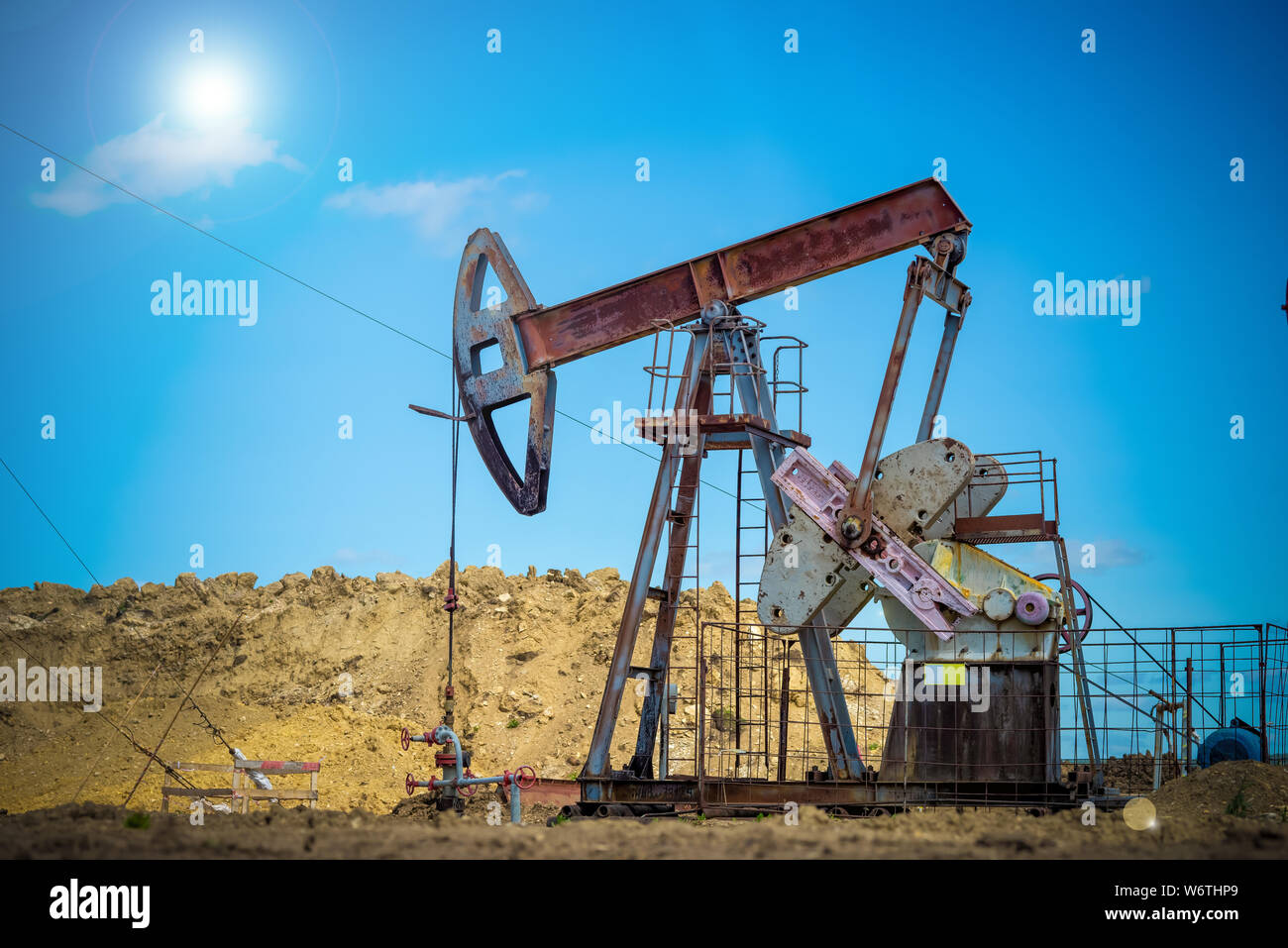 Oil pumpjack on sky clouds background. Oil well industry Stock Photo - Alamy