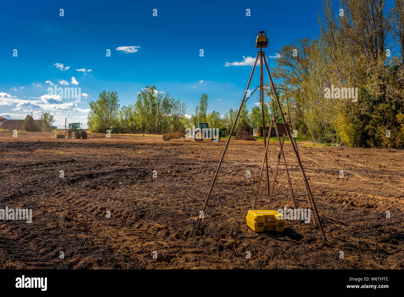 Tractors leveling in the field Stock Photo - Alamy