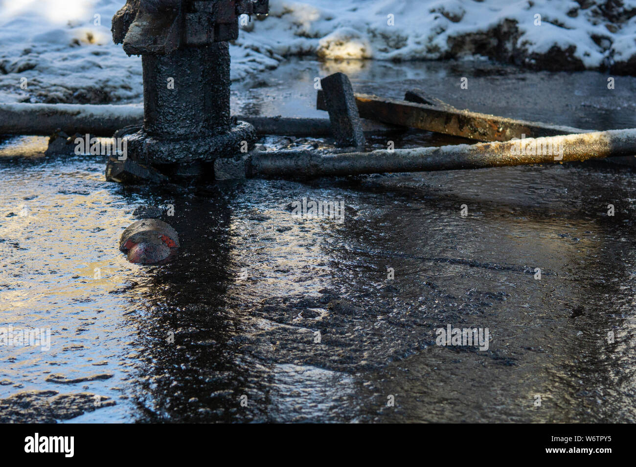 A close up of the surface of black oil pollution on water. Closeup of ...