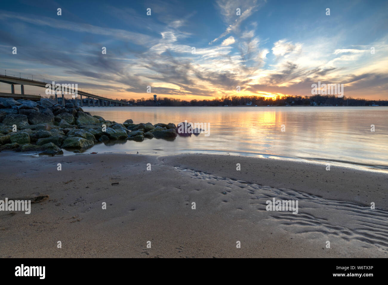 Colorful sunset skies from sandy shore of the Severn River Annapolis ...
