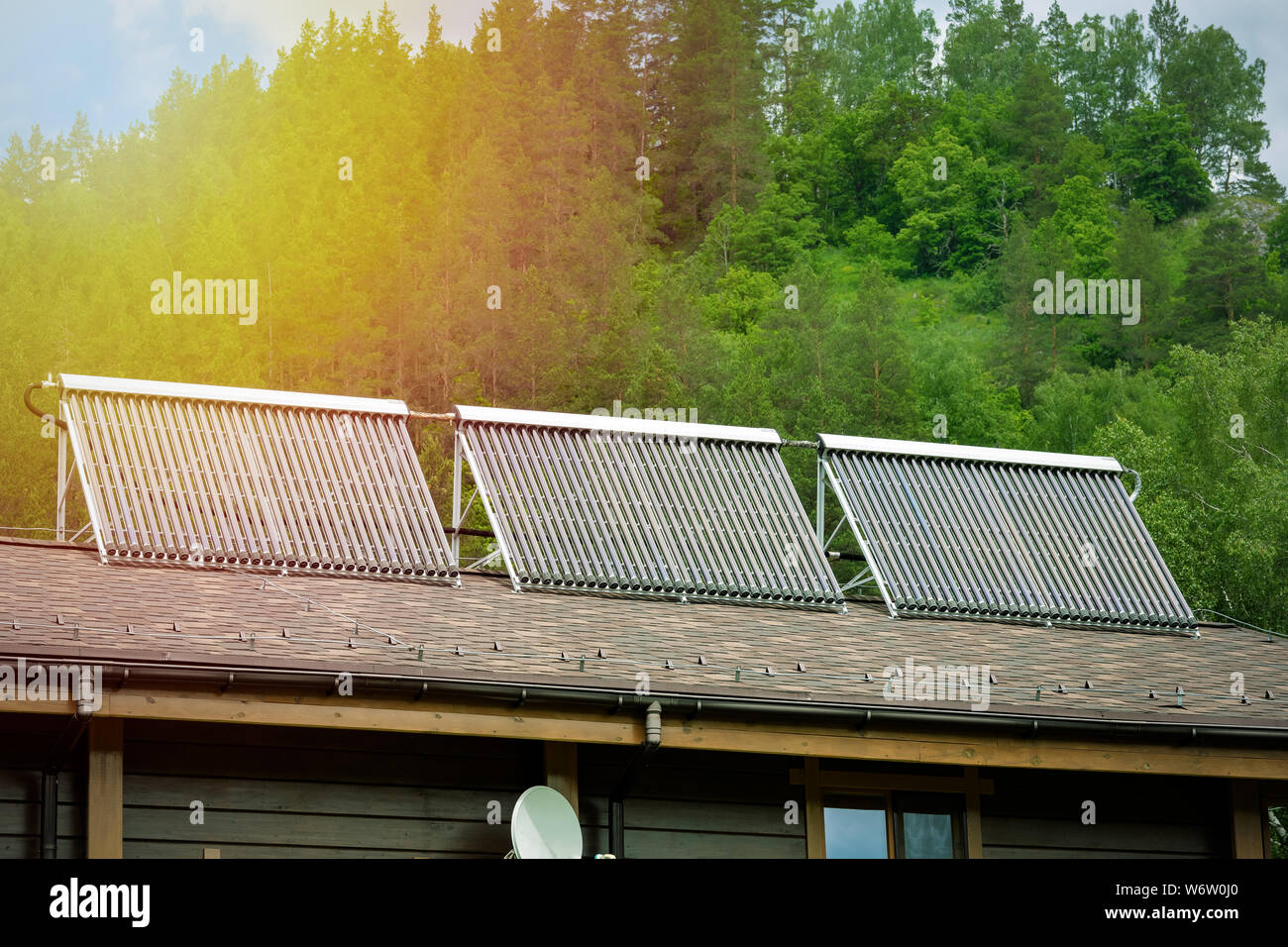 Solar glass tube hot water panel array on a roof Stock Photo - Alamy