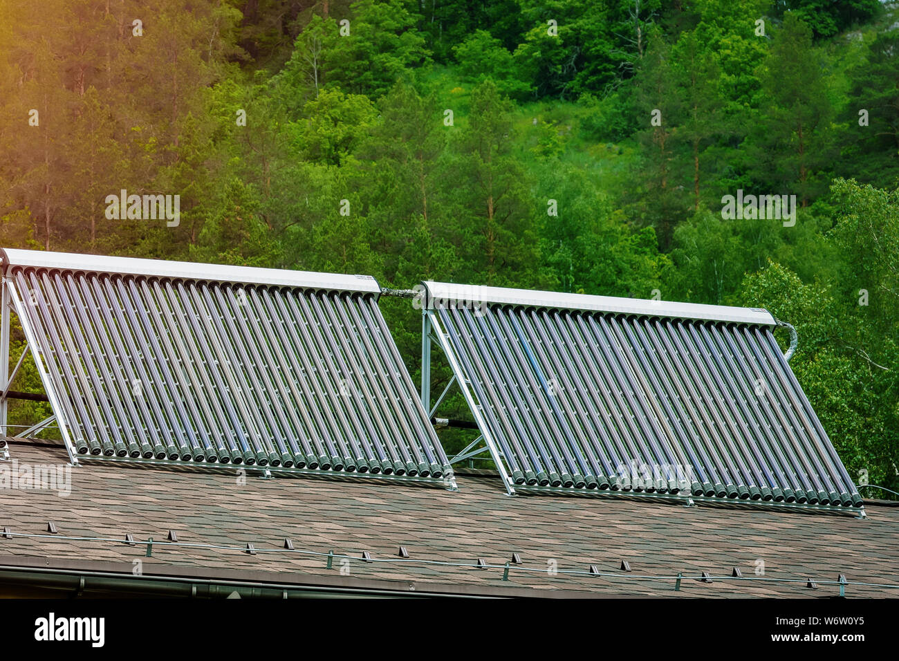 Solar glass tube hot water panel array on a roof Stock Photo - Alamy