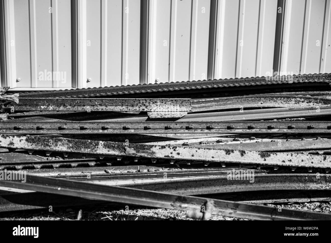 Pile of rusted steel fence posts on the ground Stock Photo - Alamy