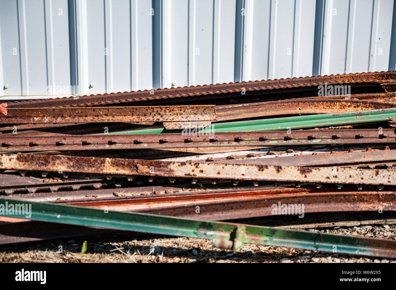 Pile of rusted steel fence posts on the ground Stock Photo - Alamy